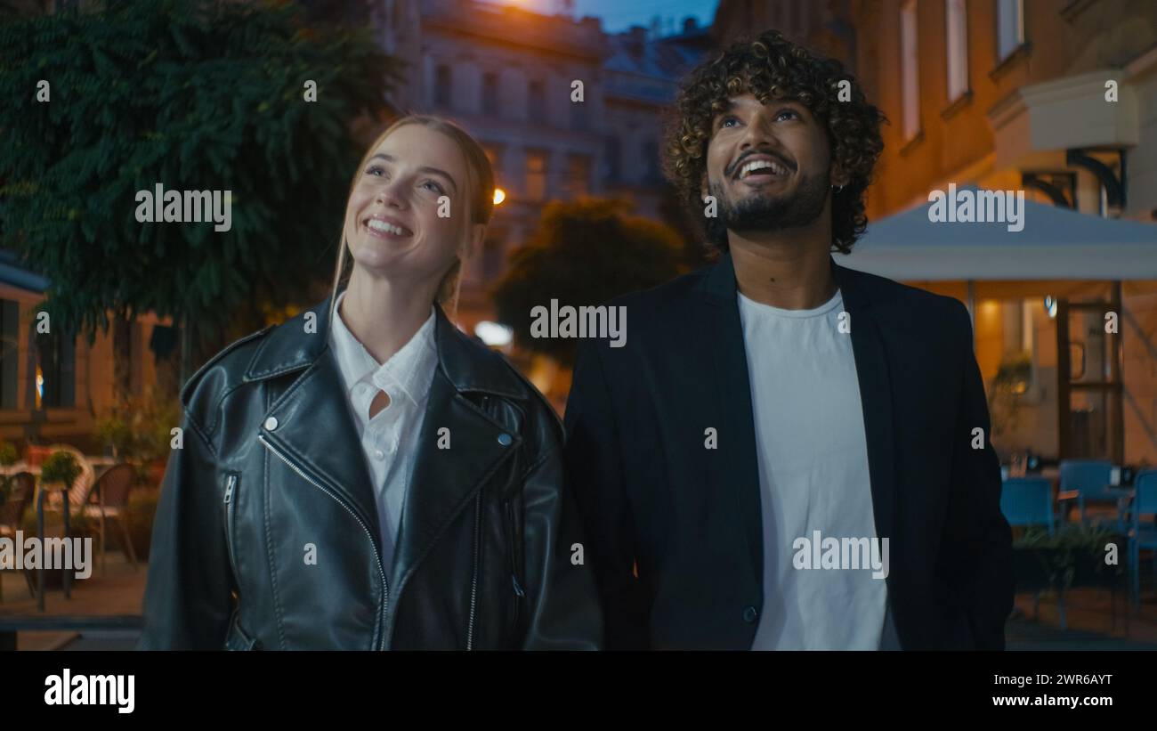 Couple Indian Latino Arabian man and European woman walking city center ...