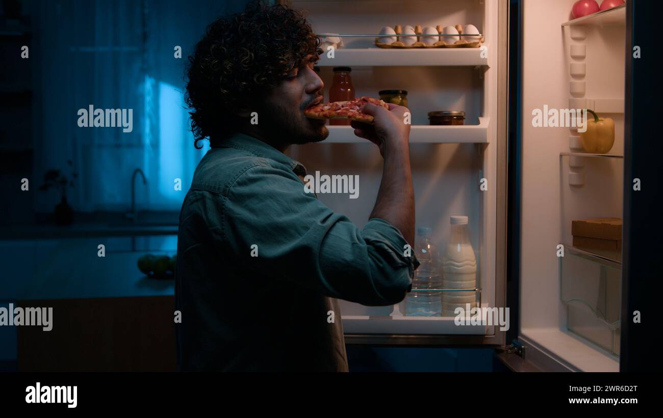 Home kitchen at night dark room hungry Hispanic man Indian male guy ...
