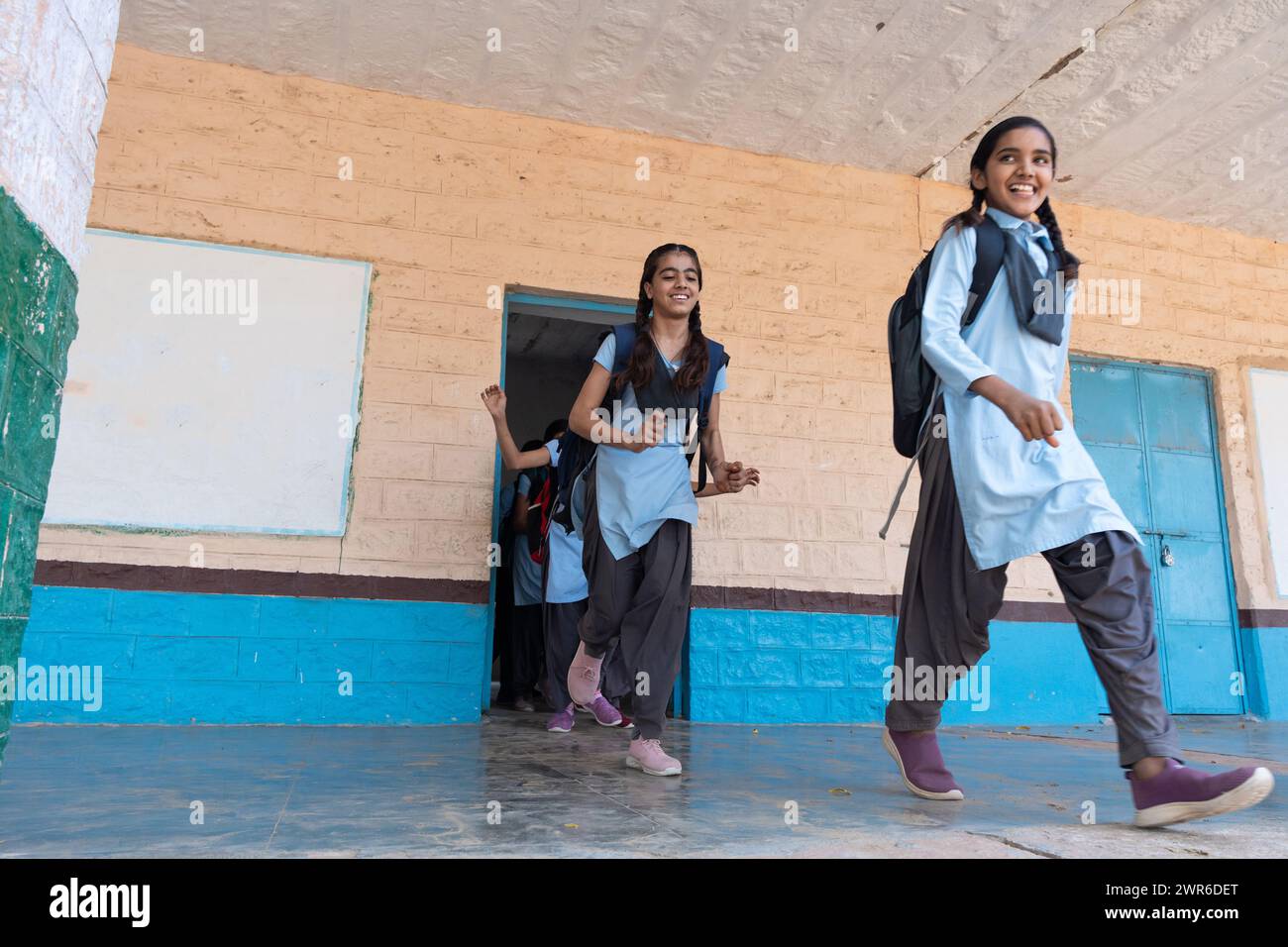 Group of indian rural children in school uniform running in school ...