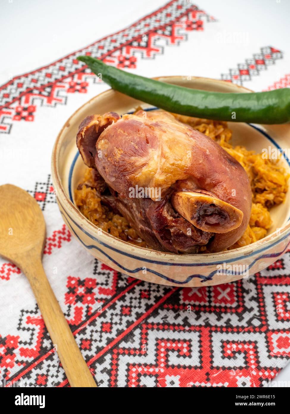 Bacon-wrapped bacon on rice with pepper garnish Stock Photo - Alamy
