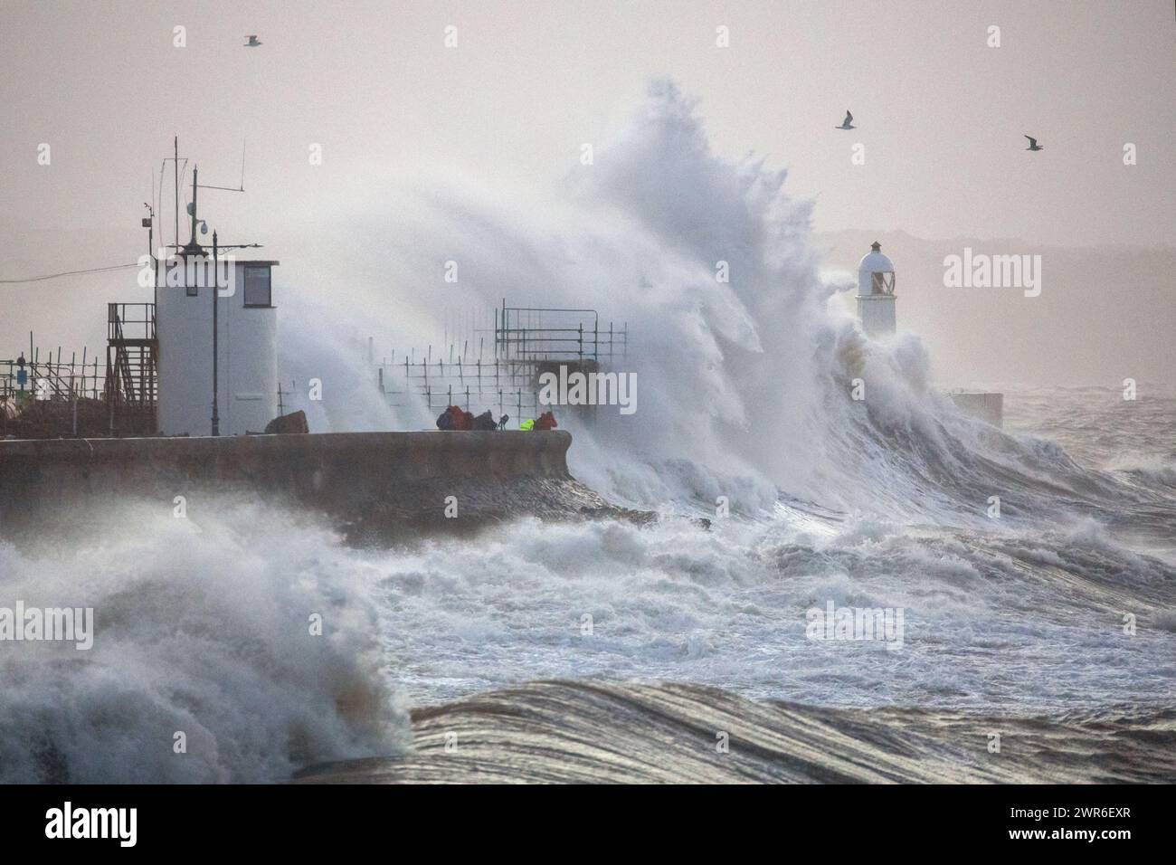 18/02/22 Photographers brave huge waves which crash over the 30ft-high ...