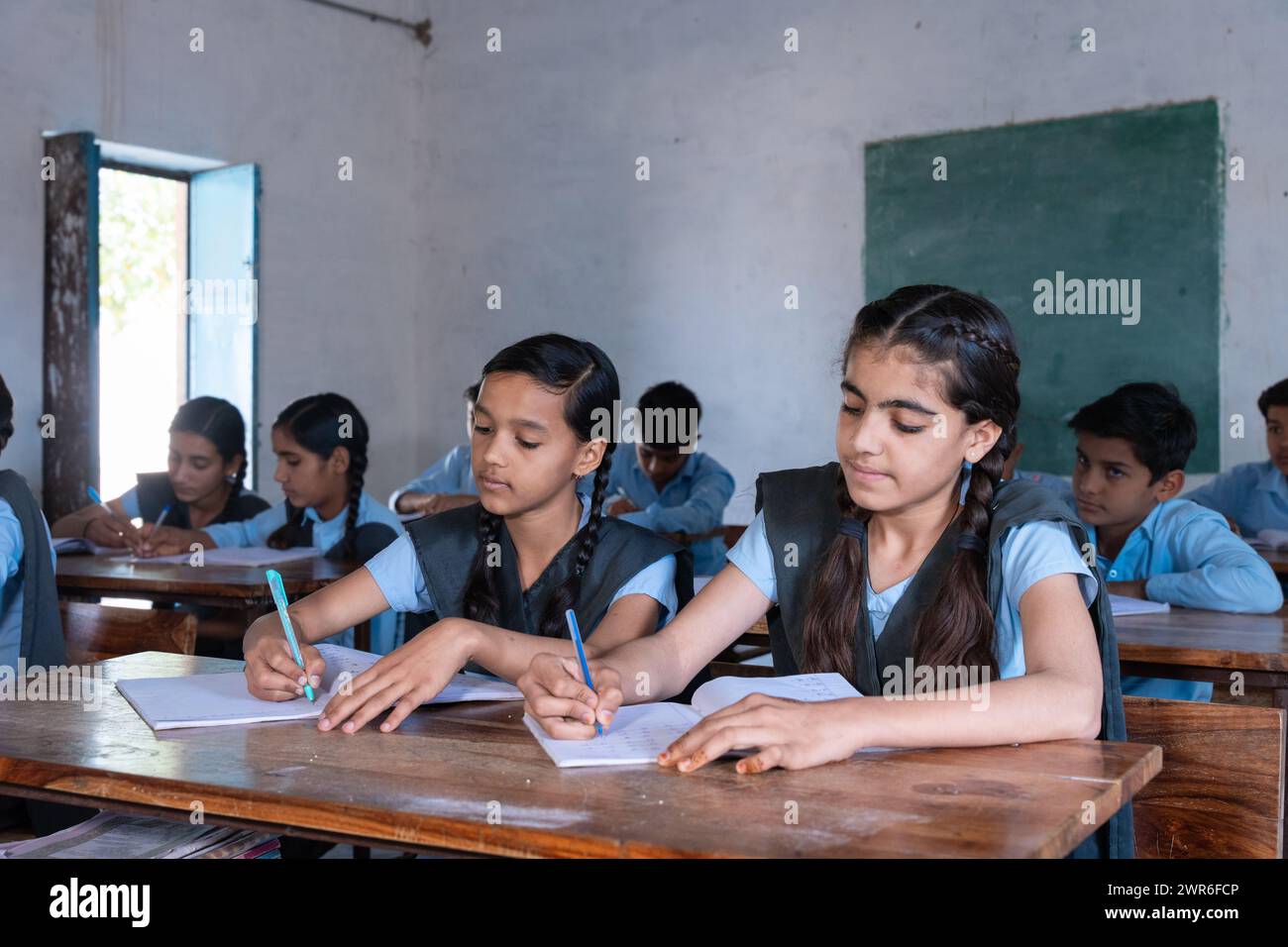 Group of indian village students in school uniform sitting in classroom ...