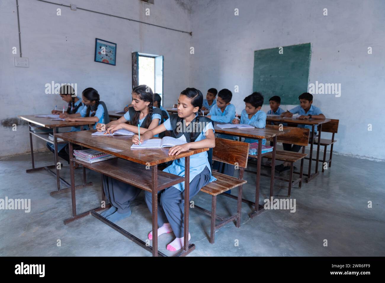 Group of indian village students in school uniform sitting in classroom ...