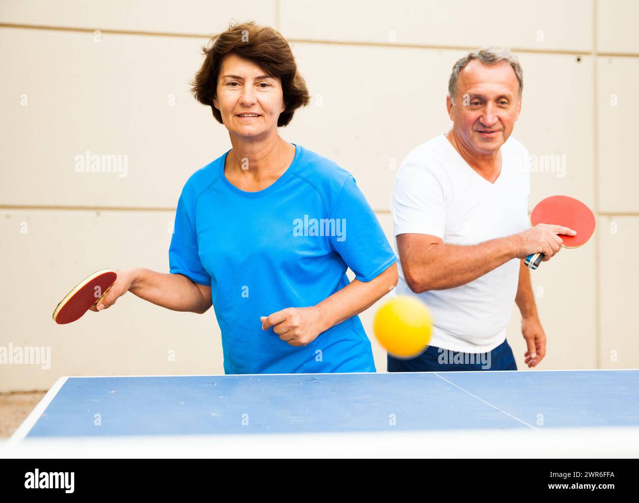 Old couple playing table tennis hi-res stock photography and images - Alamy