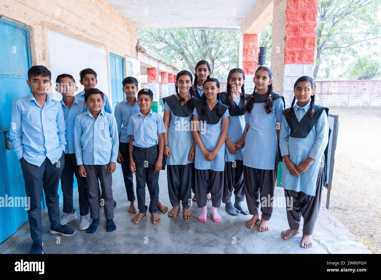 Happy indian rural children in school uniform standing looking at ...
