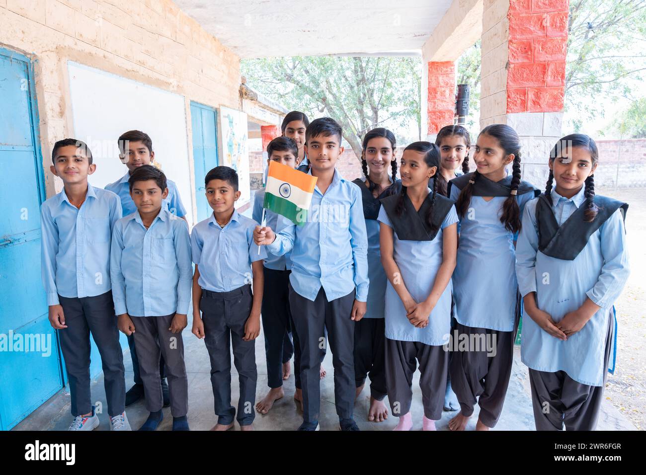 Group of happy village children in school uniform celebrating ...