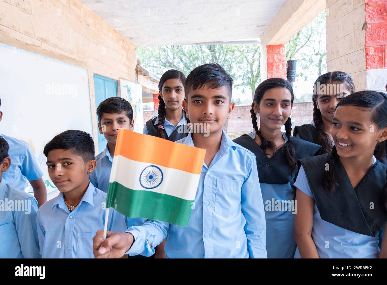 Group of happy village children in school uniform celebrating ...