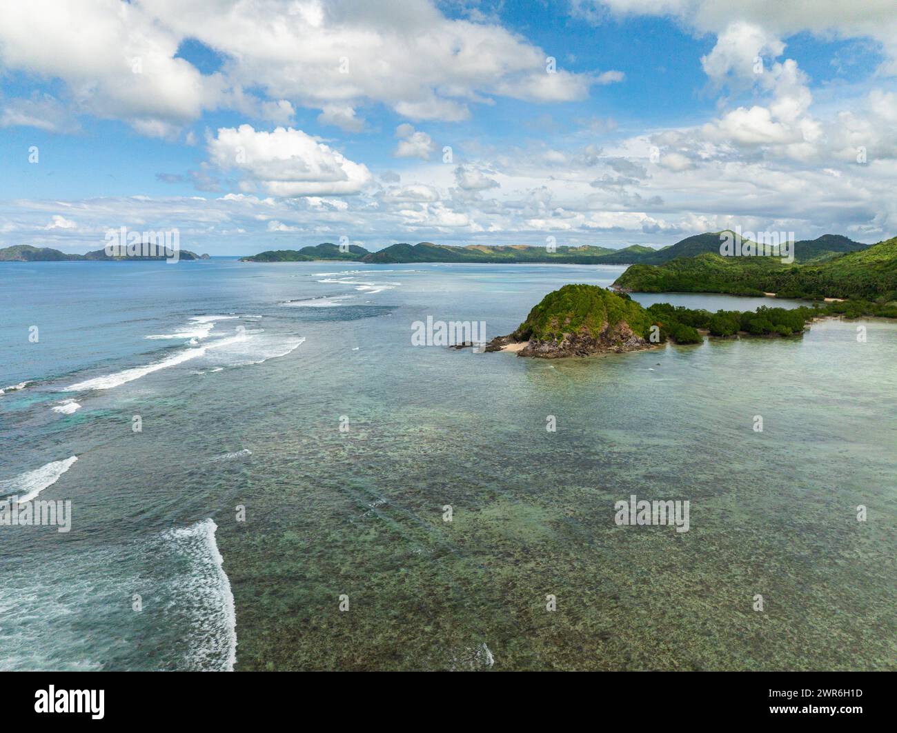 Drone view of island with ocean waves. Transparent sea water in ...