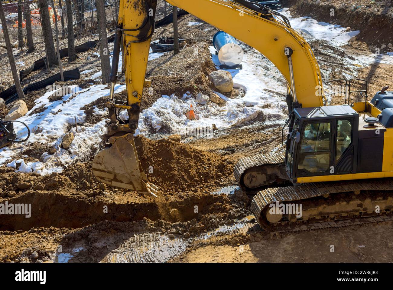 Large excavator is digging earthwork on an industrial site under ...