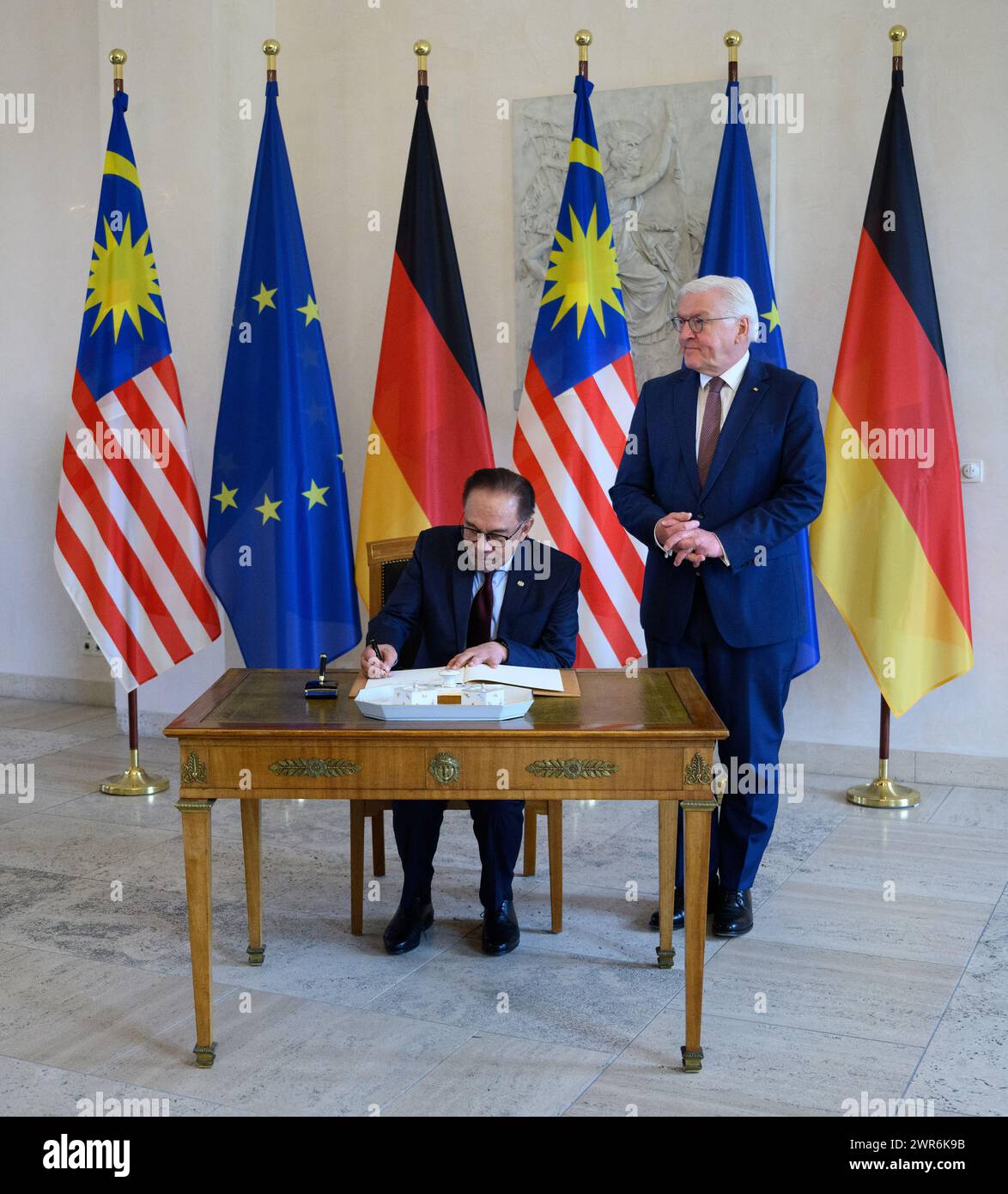 11 March 2024, Berlin: Anwar Ibrahim, Prime Minister of Malaysia, signs ...