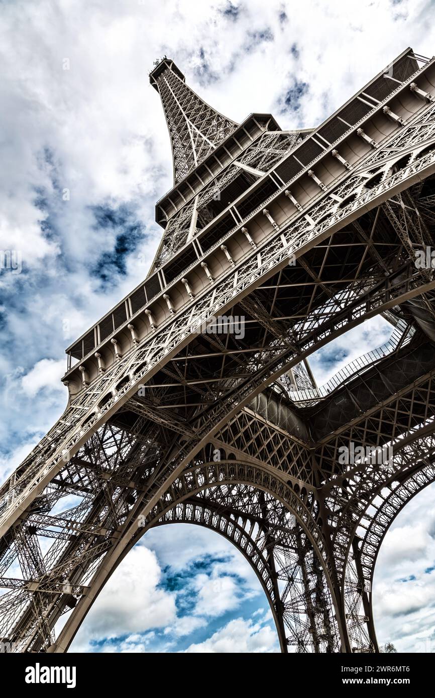 Eiffel Tower with blue sky and cloud background. Low angle view looking ...