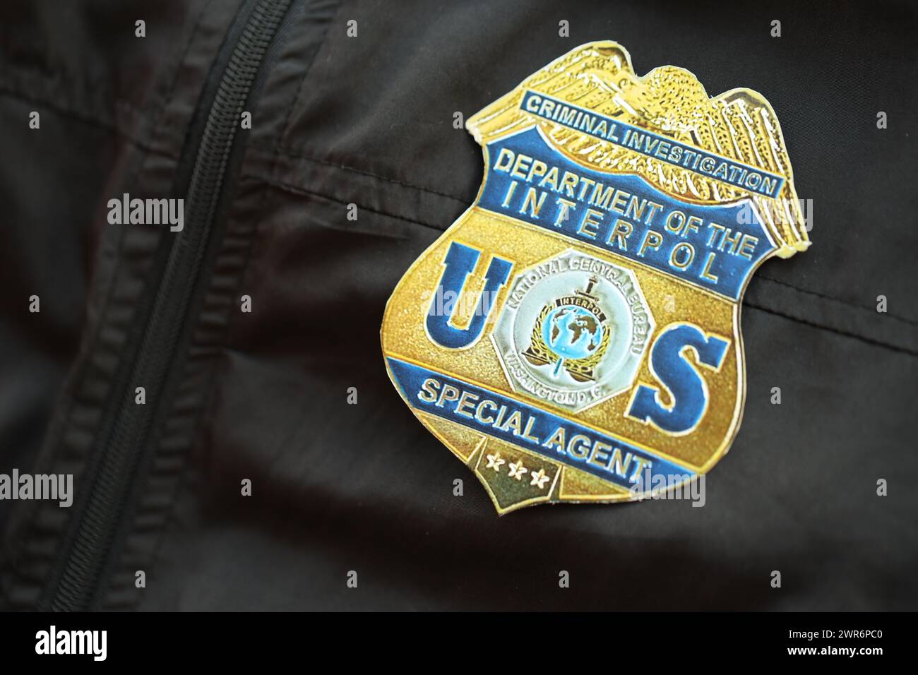 KYIV, UKRAINE - MARCH 9, 2024 US Interpol Special Agent badge on black ...