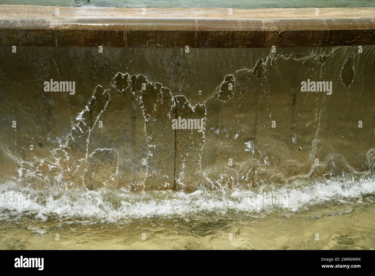 A sheet of water flowing out of a fountain, frozen by high shutter ...