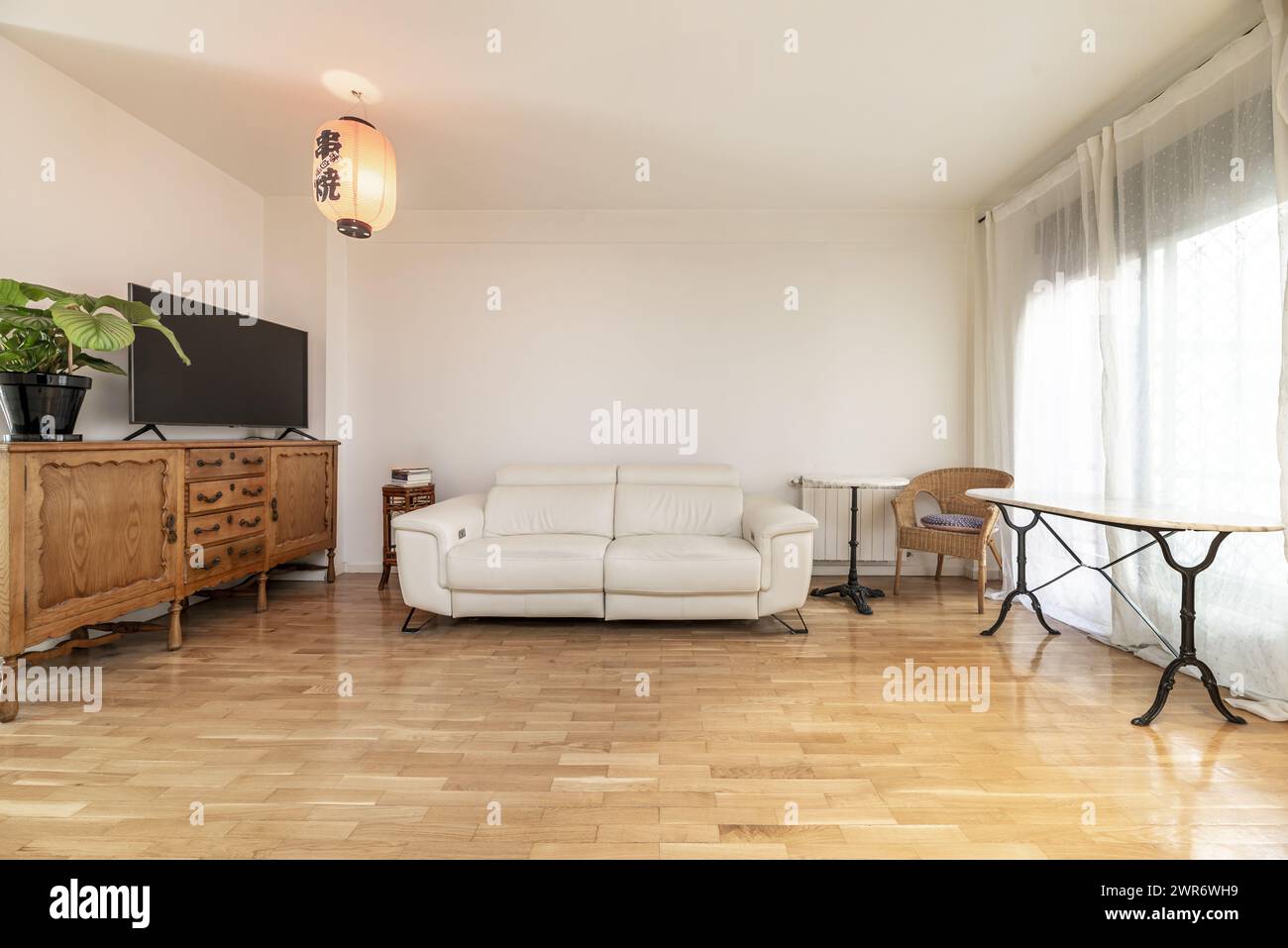 Apartment with kitchen with brown furniture, white countertop, stools ...