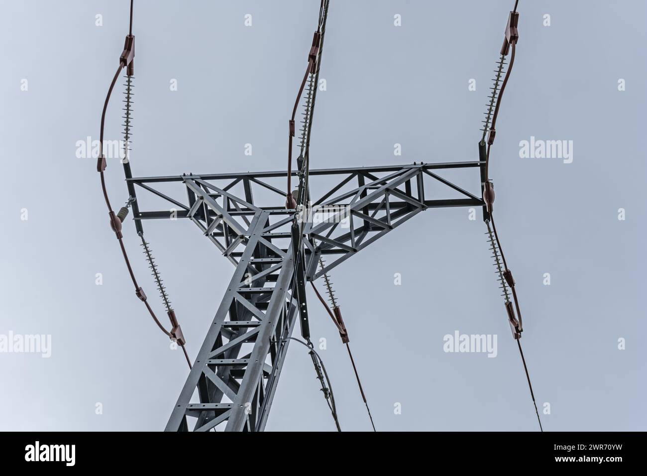 A high voltage tower transporting electricity through its cables Stock ...
