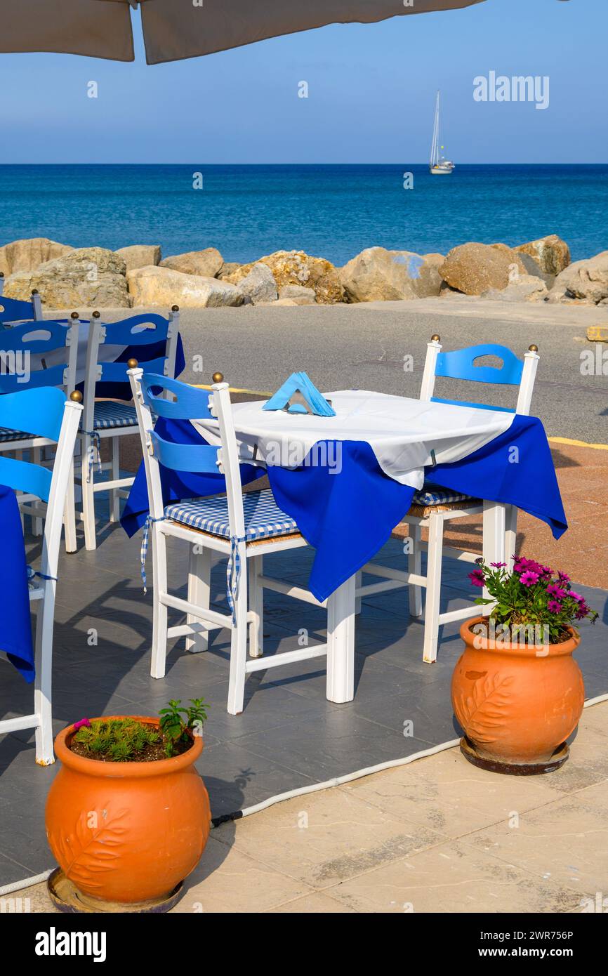 Tables with chairs in Greek seaside restaurant. Kardamena village on ...