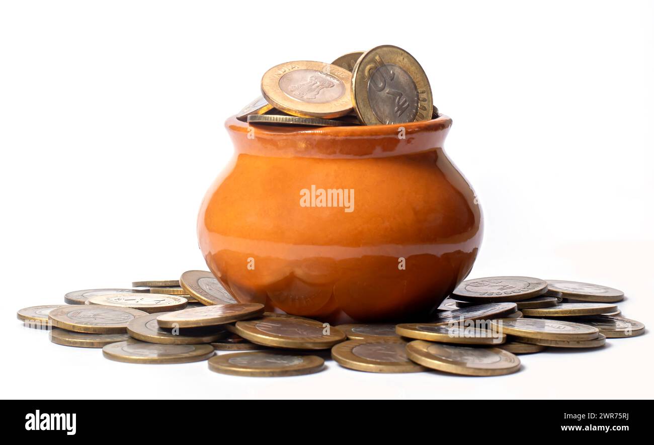 Coins in a clay pot on a white background, saving concept Stock Photo ...