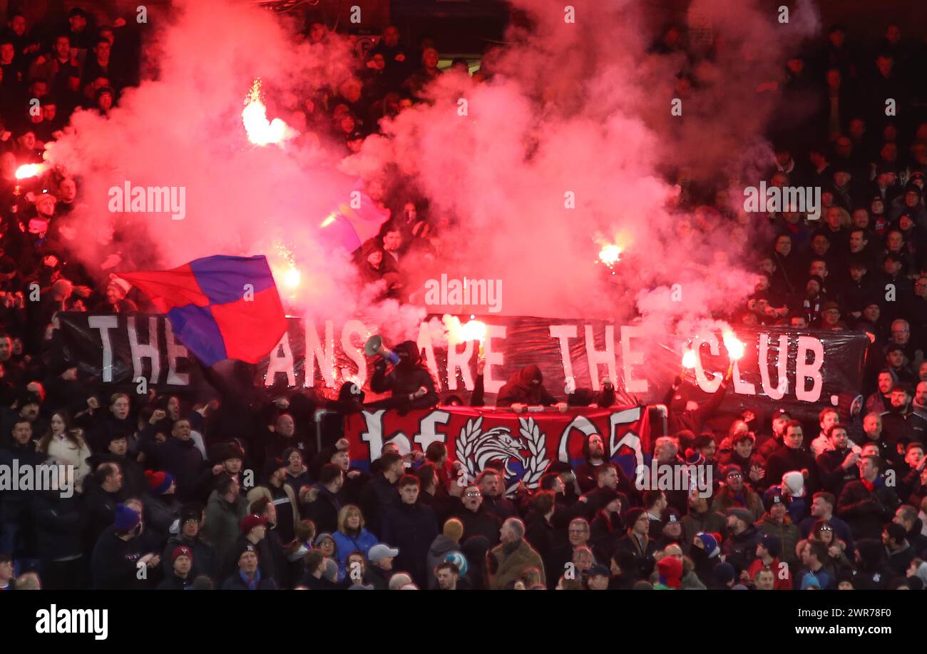 Crystal Palace fans with flares as they hold aloft banners which read ...