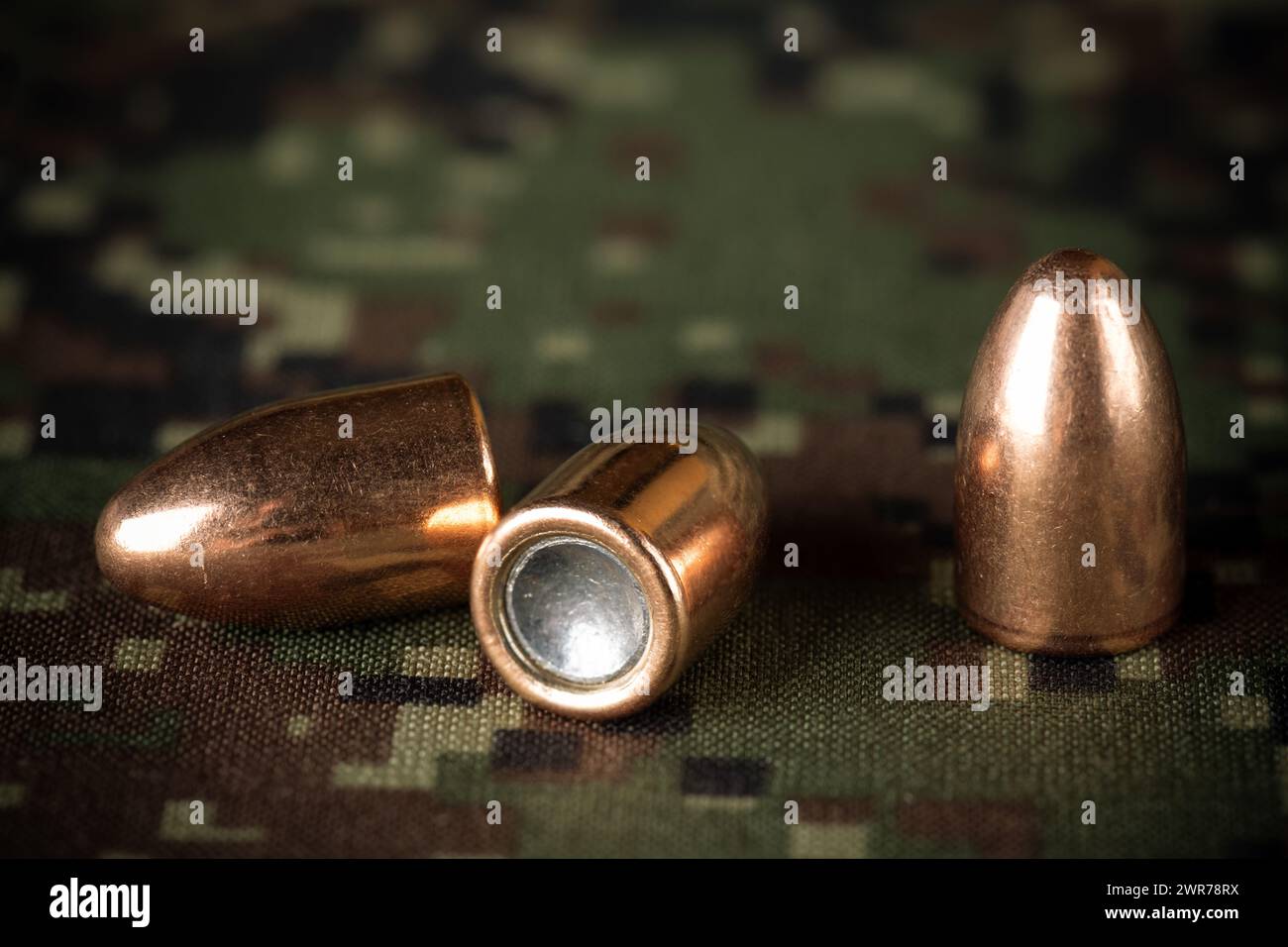 New unused bullet gun pistol set on military green background closeup ...