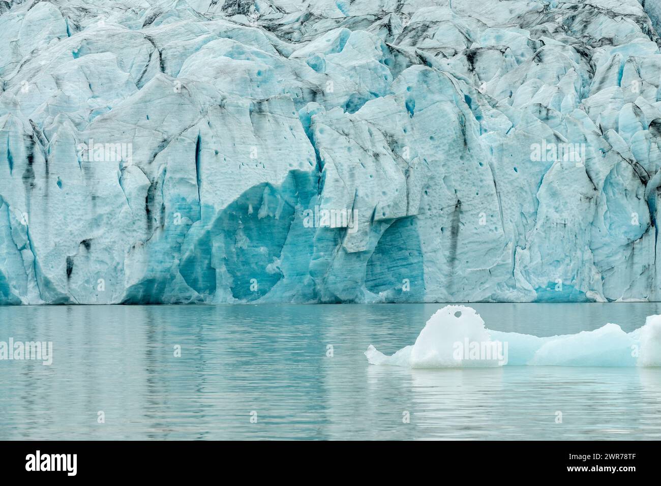 Ice wall and icebergs in Fjallsarlon glacier lagoon, abstract landscape ...