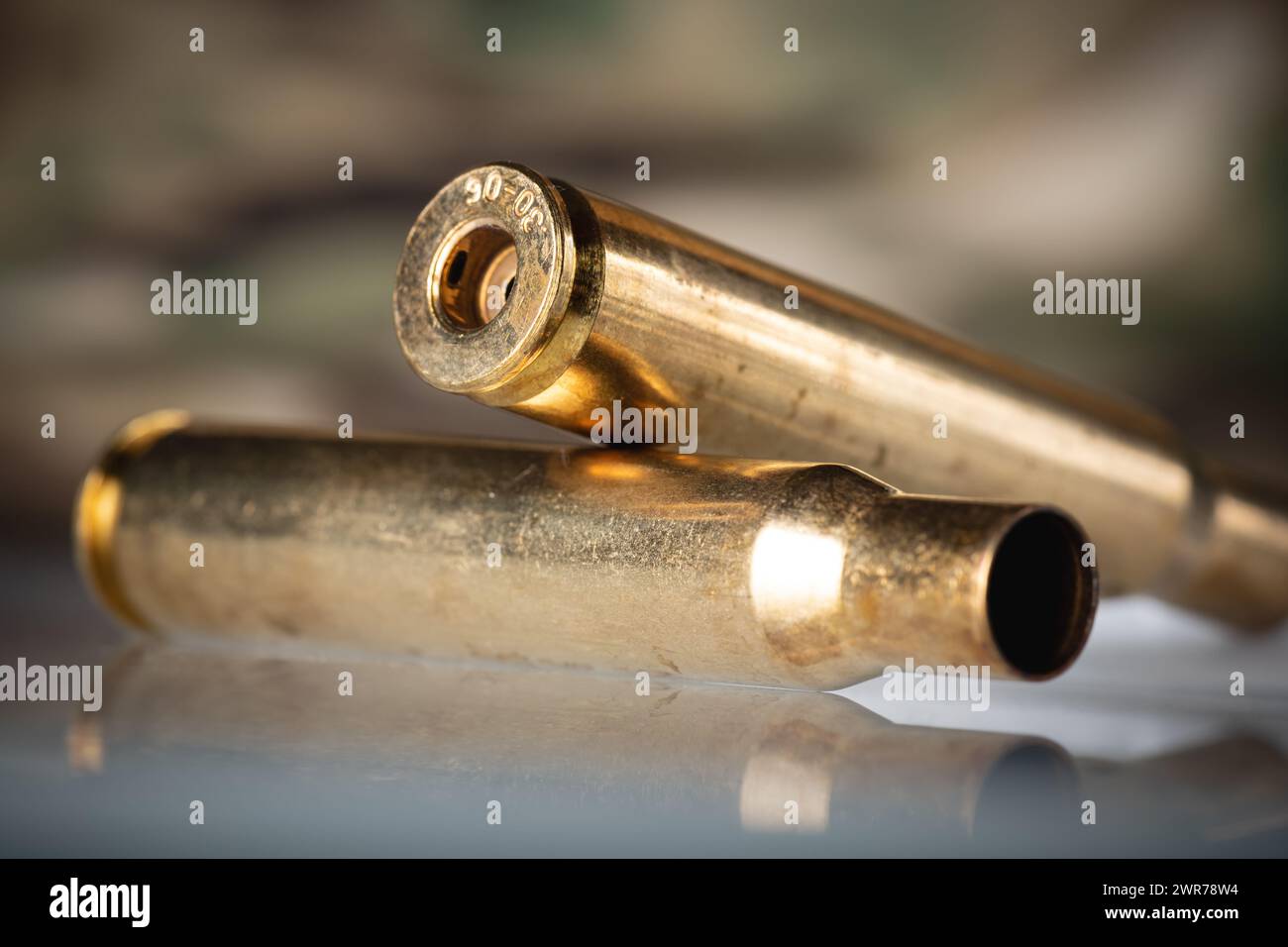 Demounted bullet shells on camouflage background closeup Stock Photo ...