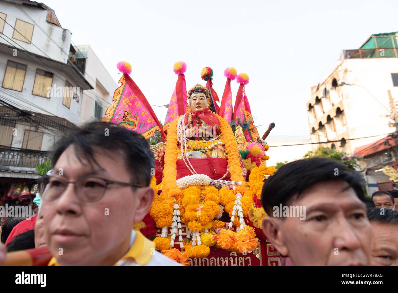 Believers parade a statue replica of Chao Mae Lim Ko Niao god, a deity ...