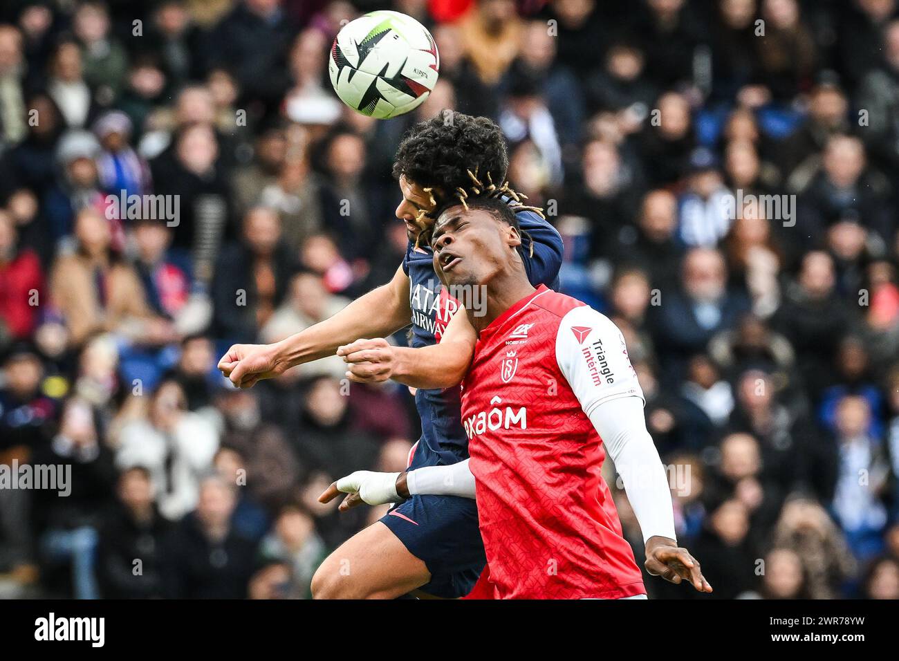 Paris, France. 10th Mar, 2024. Goncalo RAMOS of PSG and Emmanuel AGBADOU of Reims during the ...
