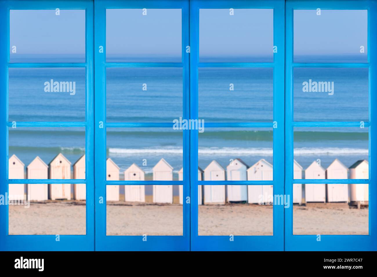Blue window with a view on a beach with vintage white cabins Stock ...
