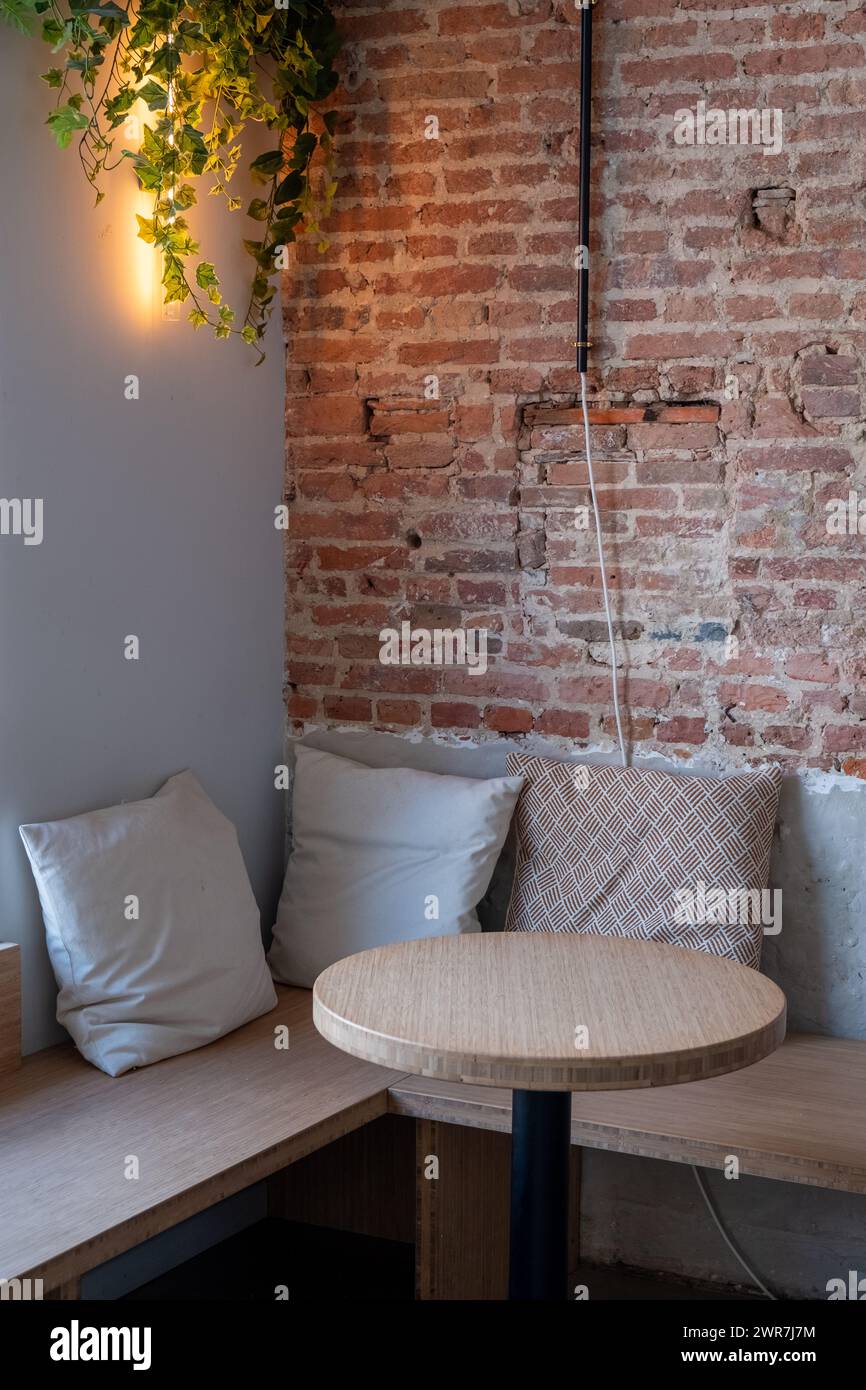 The image displays a welcoming nook within a modern cafe, marrying ...