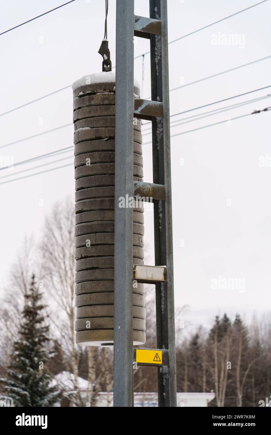 Counterweights for railway overhead electric wires in winter Stock ...
