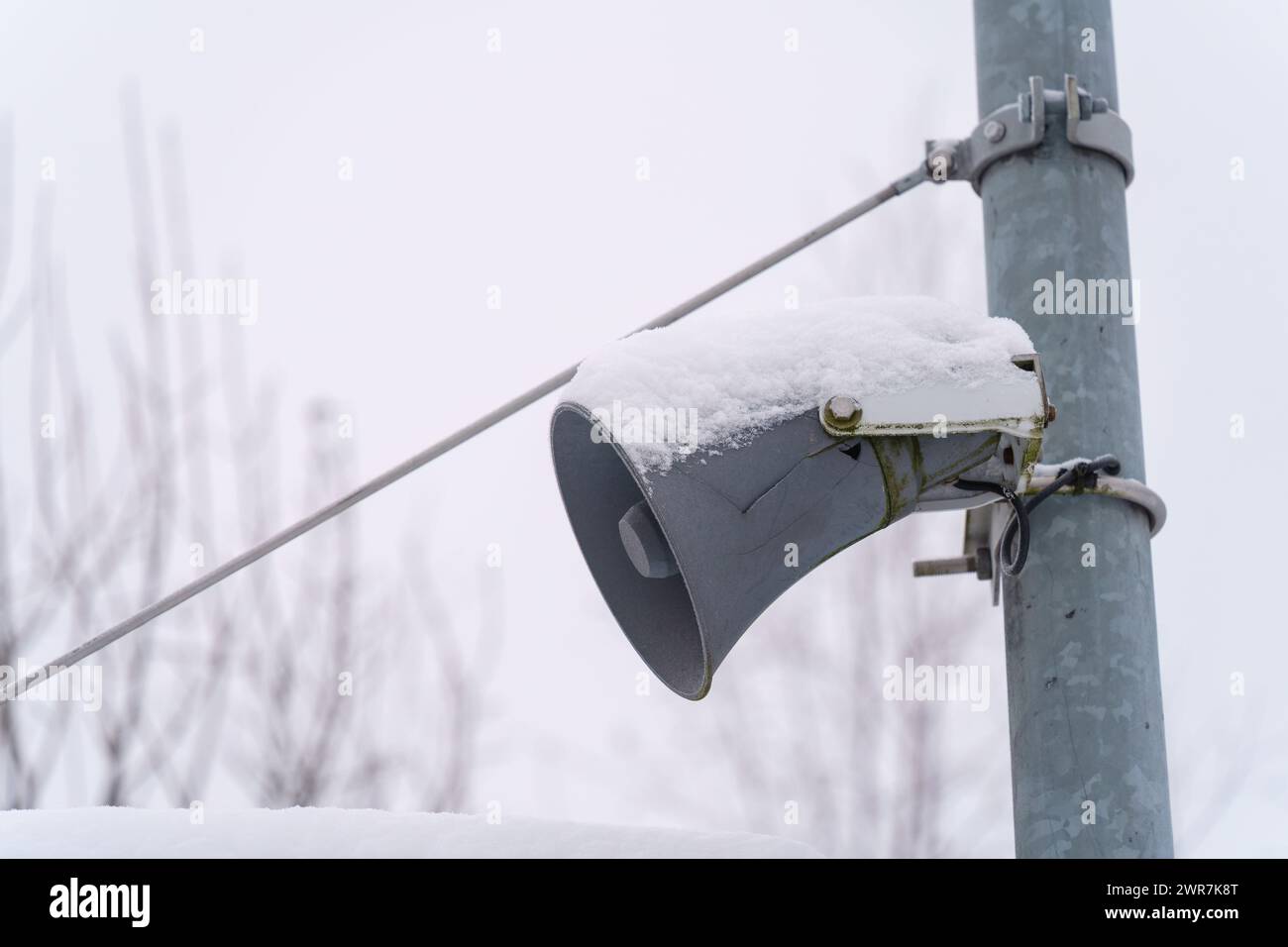 Close up of announcement loudspeaker covered in snow at the train ...