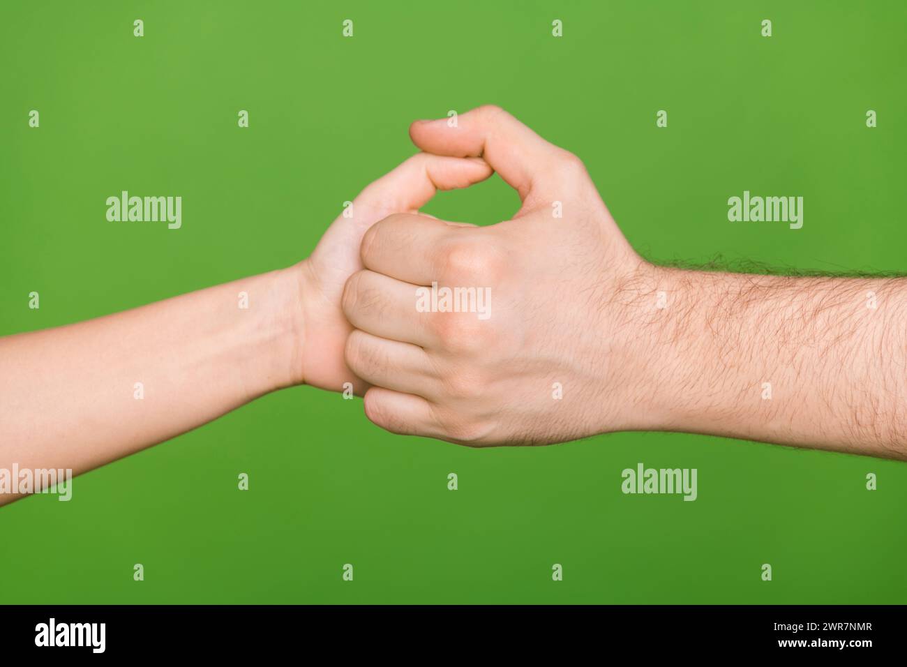 Photo of two people hands palms having fun playing thumb war game ...