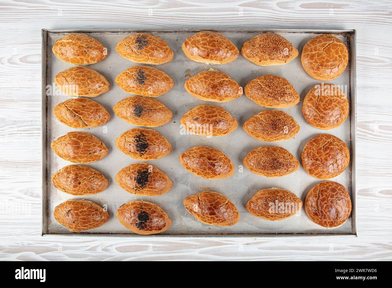 Pastries made from buckwheat flour on a baking tray. Sesame pastries ...