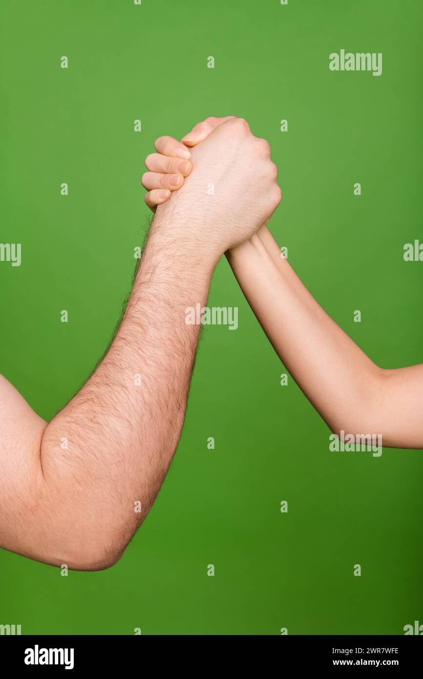 Vertical photo of two female male arms holding hands showing strength ...