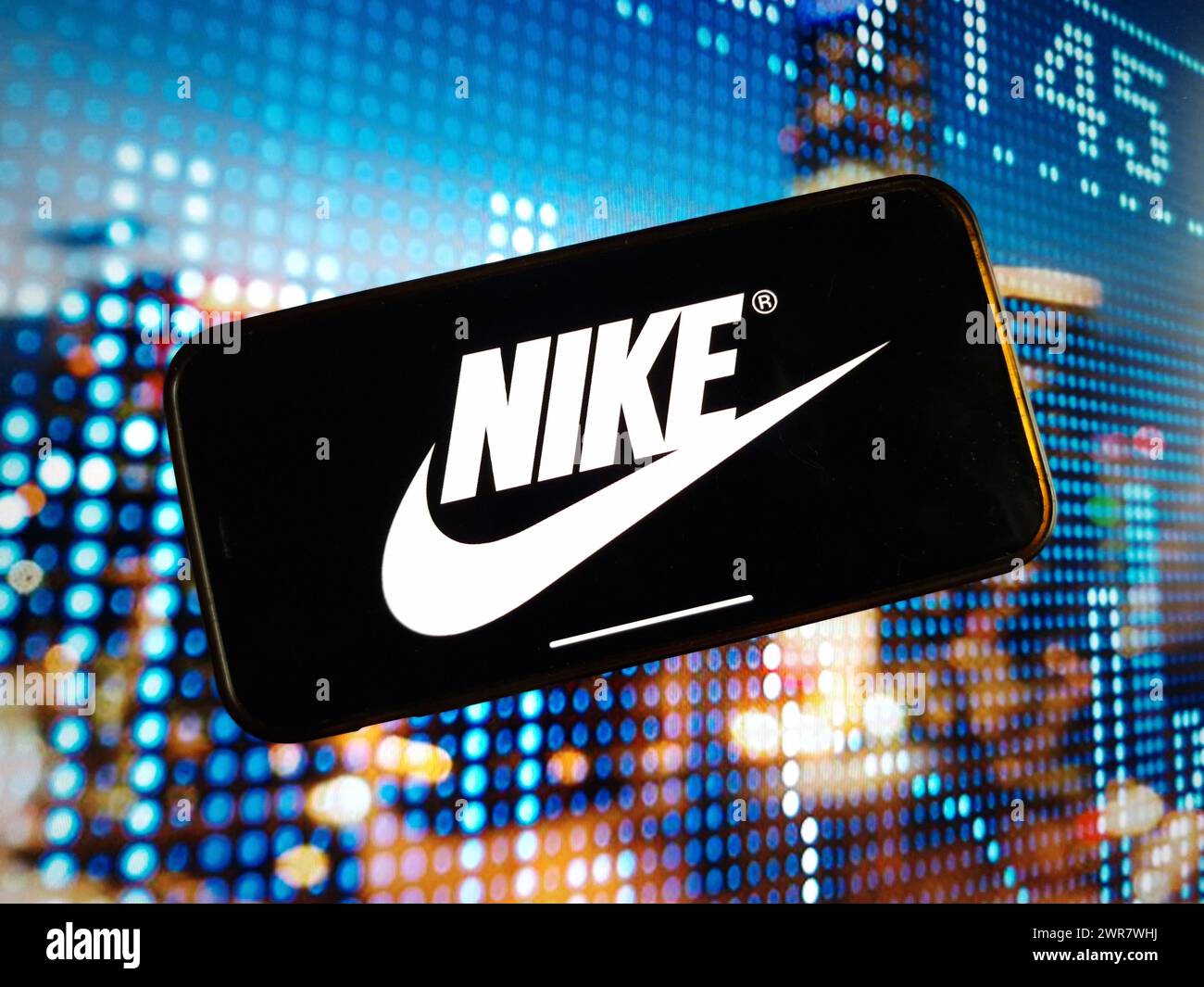 In this photo illustration, the Nike company logo is seen displayed on ...
