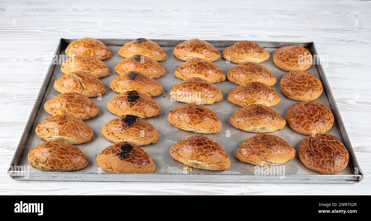 Pastries made from buckwheat flour on a baking tray. Sesame pastries ...