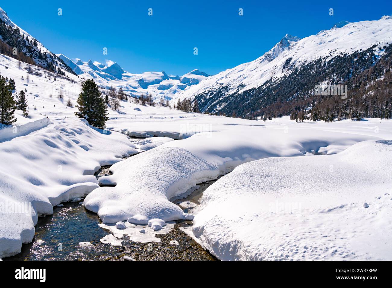 Val Roseg, in Engadine, Switzerland, in winter, with snow-covered cross ...