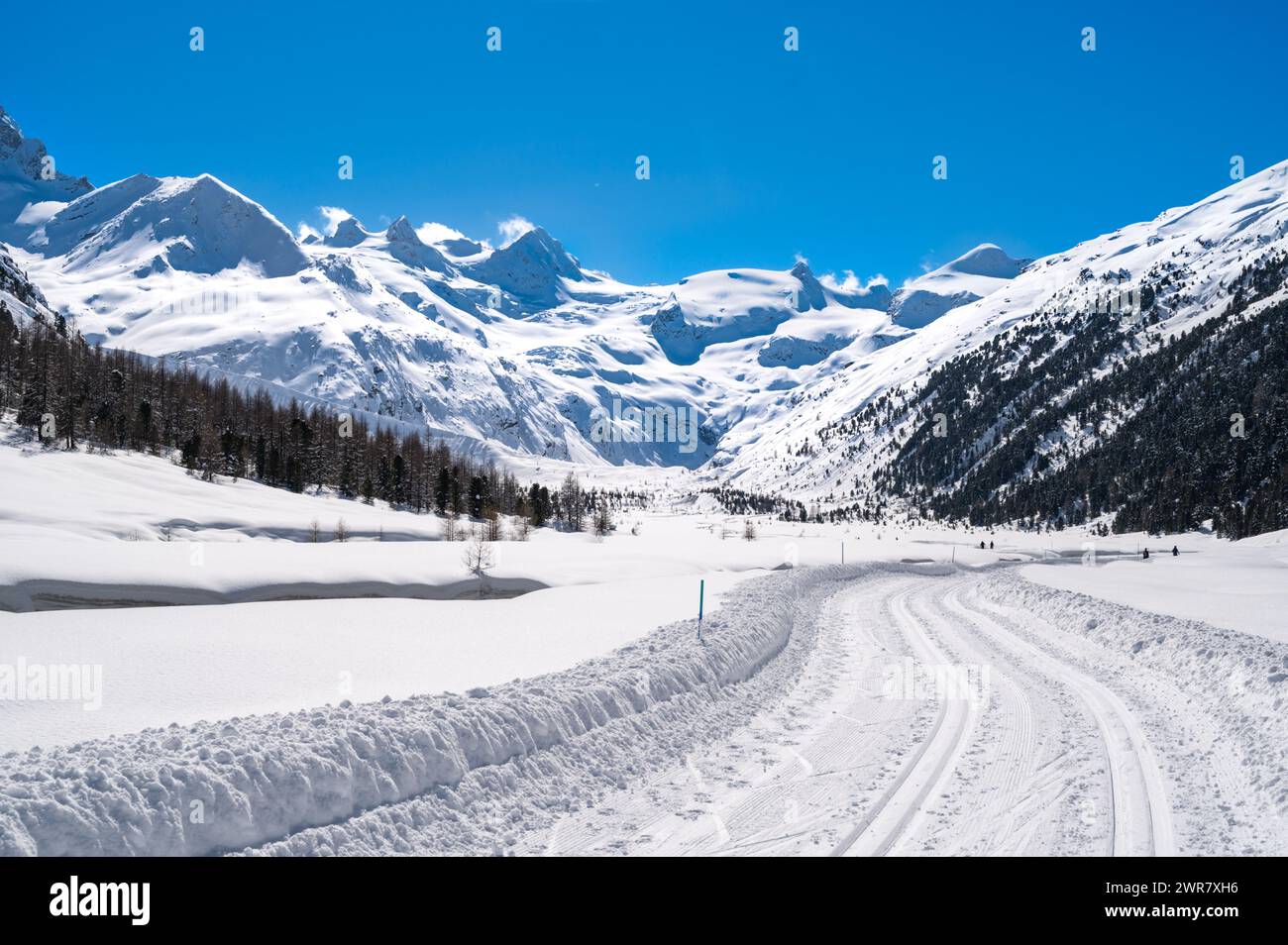 Val Roseg, in Engadine, Switzerland, in winter, with snow-covered cross ...