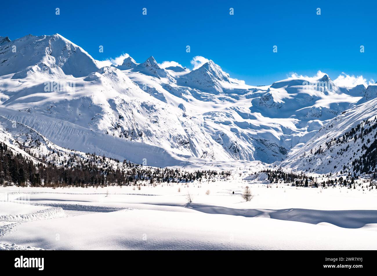 Val Roseg, in Engadine, Switzerland, in winter, with snow-covered cross ...