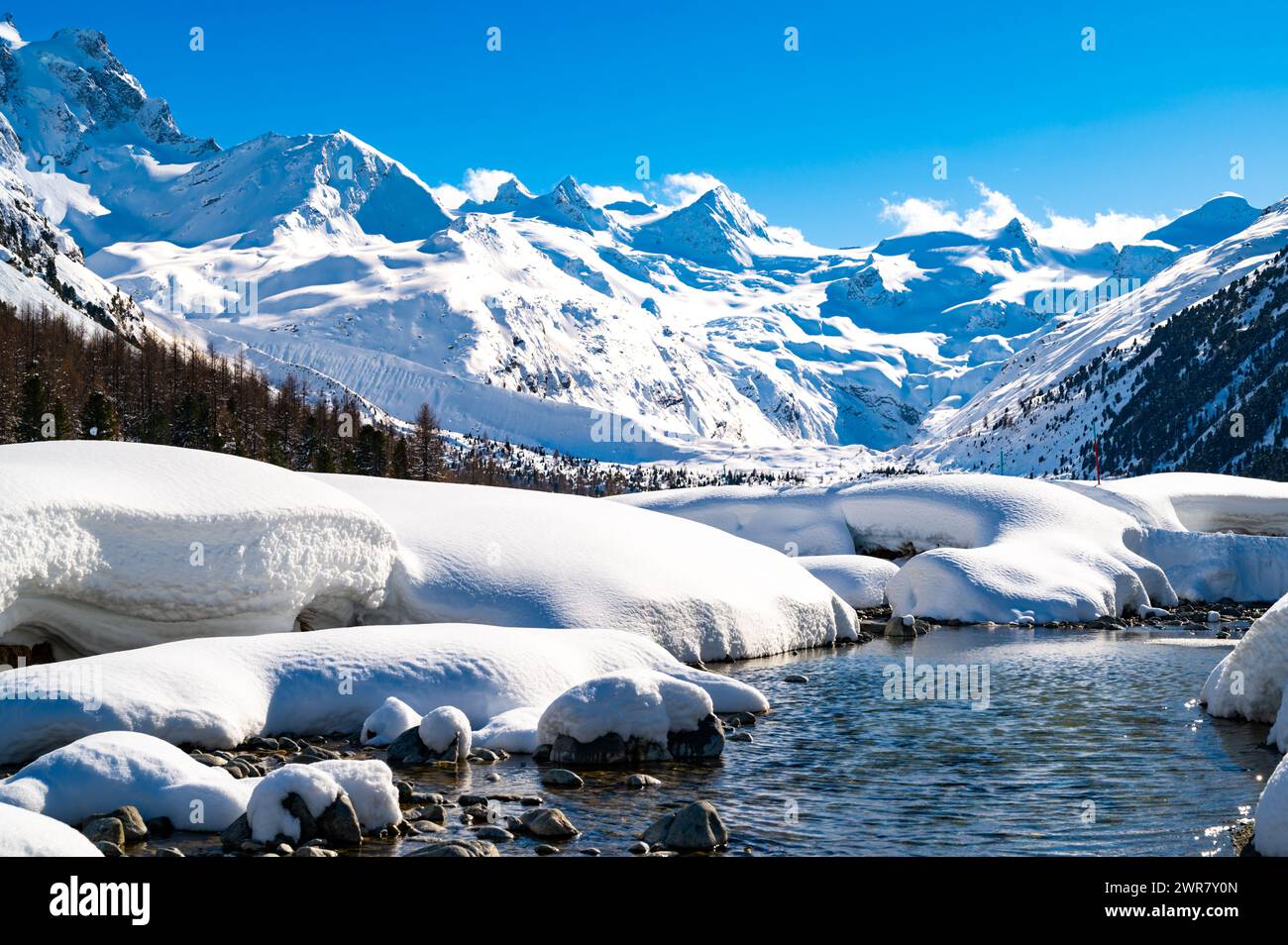 Val Roseg, in Engadine, Switzerland, in winter, with snow-covered cross ...