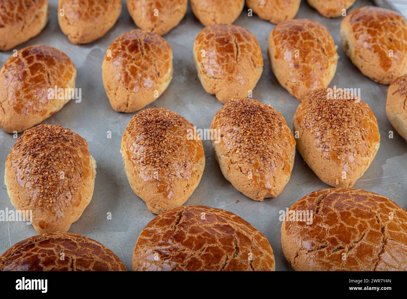 Pastries made from buckwheat flour on a baking tray. Sesame pastries ...