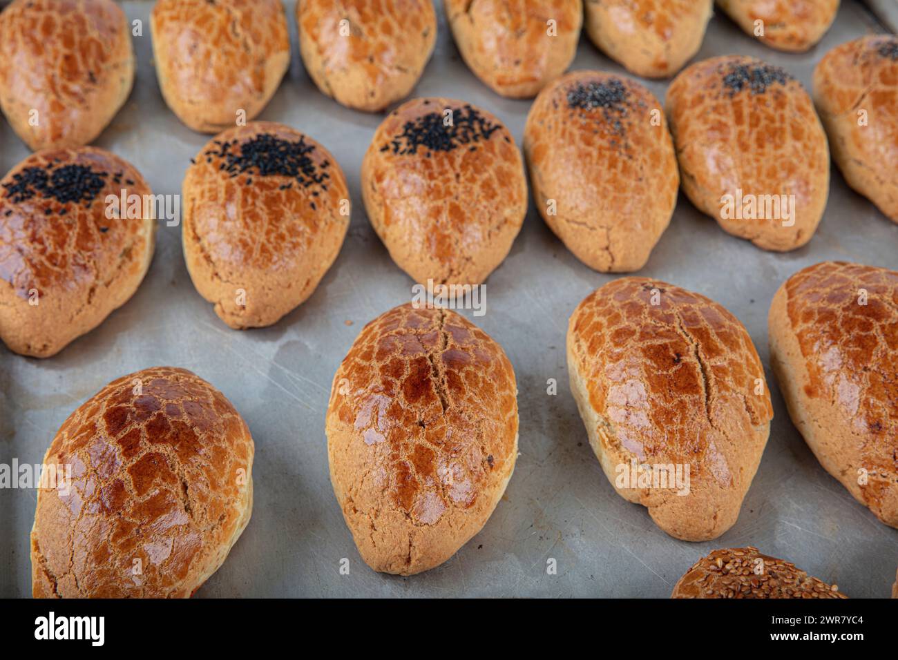 Pastries made from buckwheat flour on a baking tray. Sesame pastries ...
