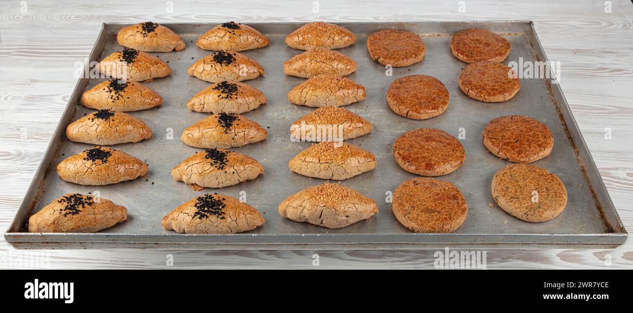 Pastries made from buckwheat flour on a baking tray. Sesame pastries ...