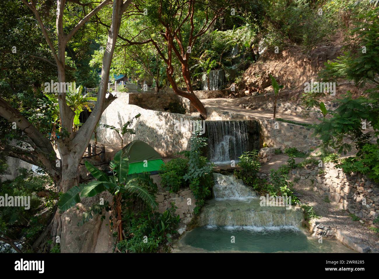 Mini waterfall forming small natural pits of turquoise water adventure ...
