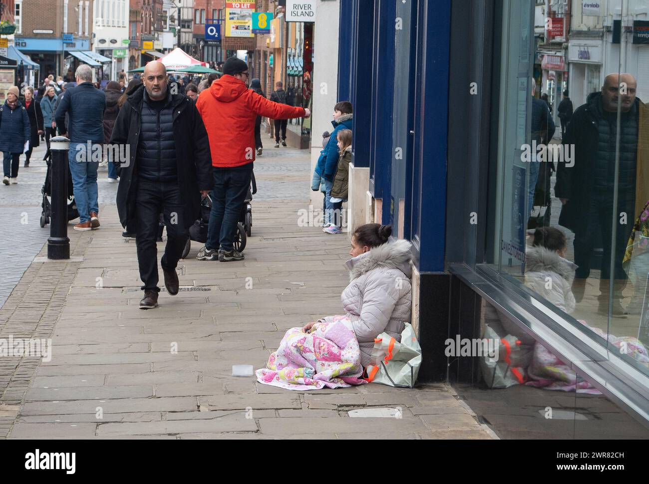 Windsor, Berkshire, UK. 9th March, 2024. A sad homeless woman sits on ...