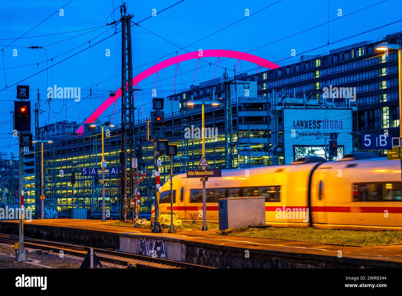 The illuminated arch of the Lanxess Arena in Deutz, train at the ...