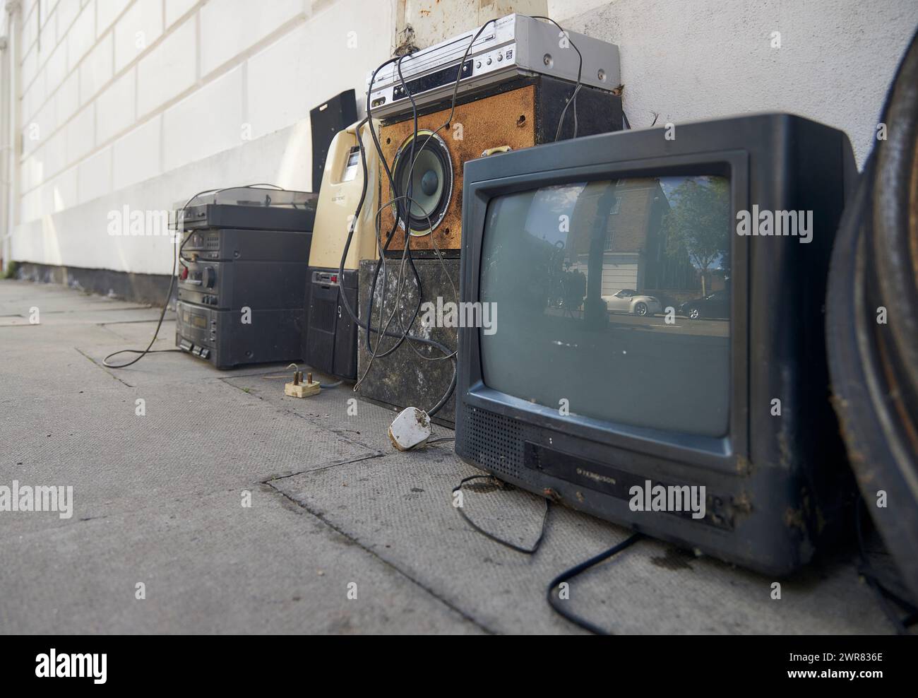 Selection of old electronic equipment dumped on a London street with ...