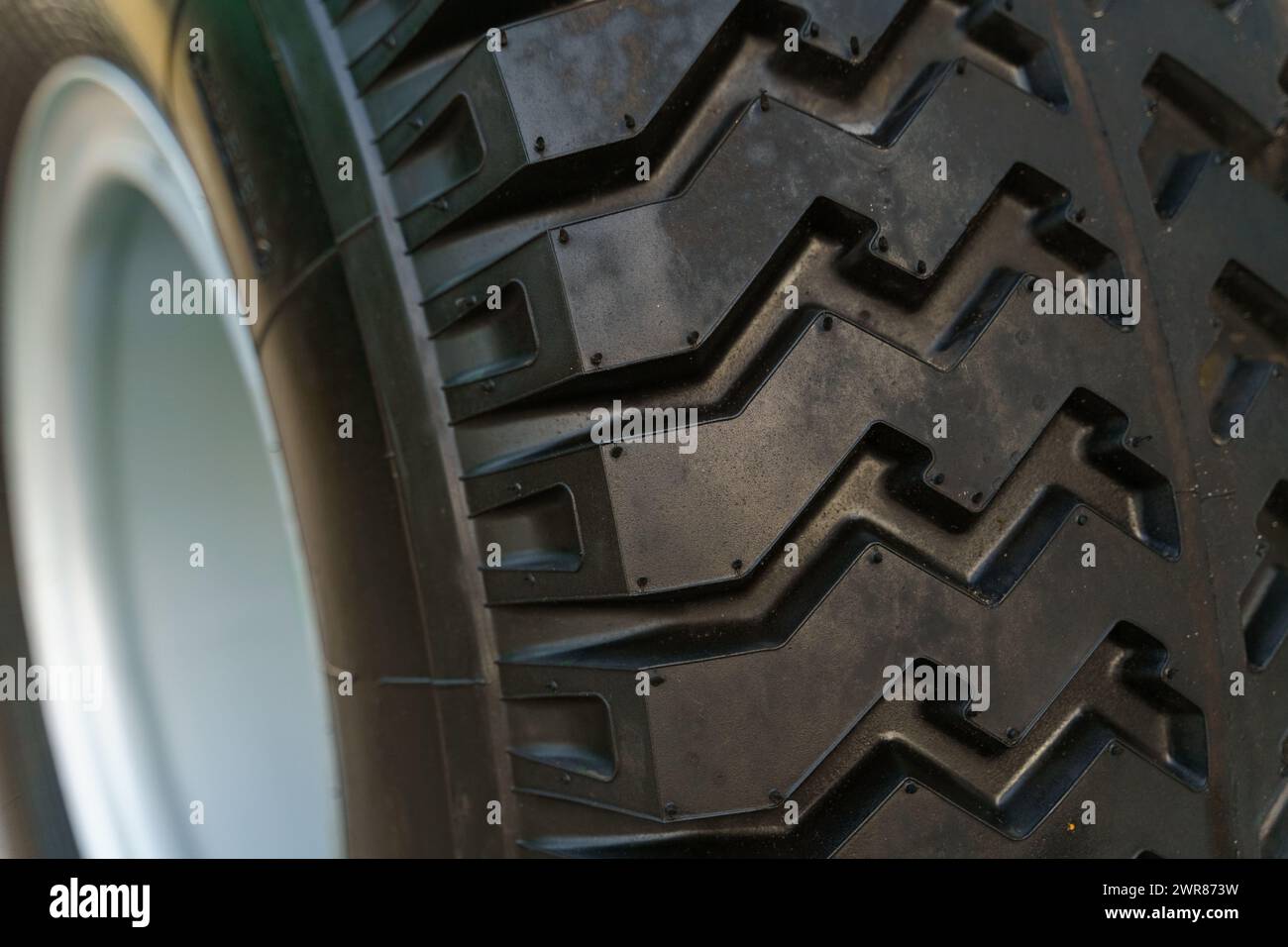 Detailed view of a tire mounted on a vehicle, showcasing the tread ...