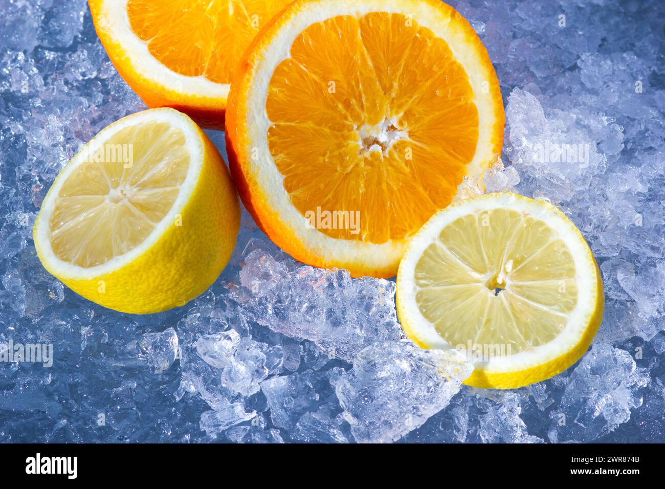 The Sliced Orange And Lemon On Chopped Ice Background. Fresh And ...