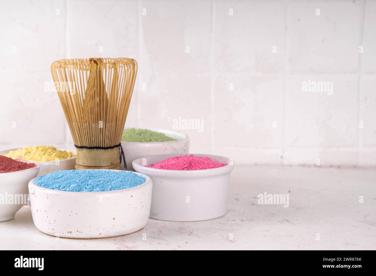 Set of dried plant matcha powder in white bowl. Various color and ...